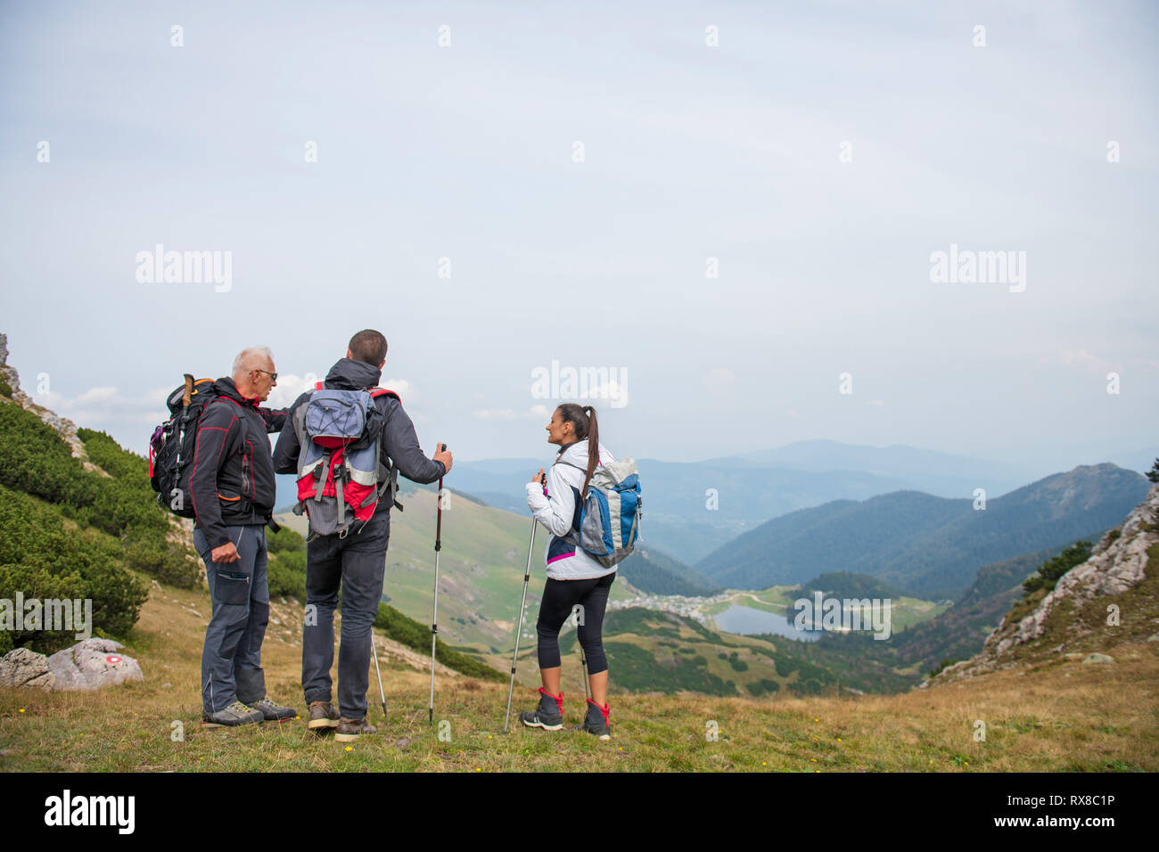 An elderly man giving a tour for a young group of people Stock Photo ...