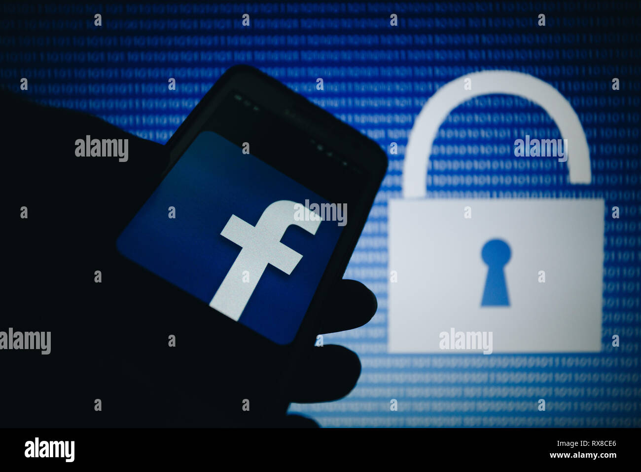 Facebook icon, logo is shown on smartphone display, open lock, numbers ...