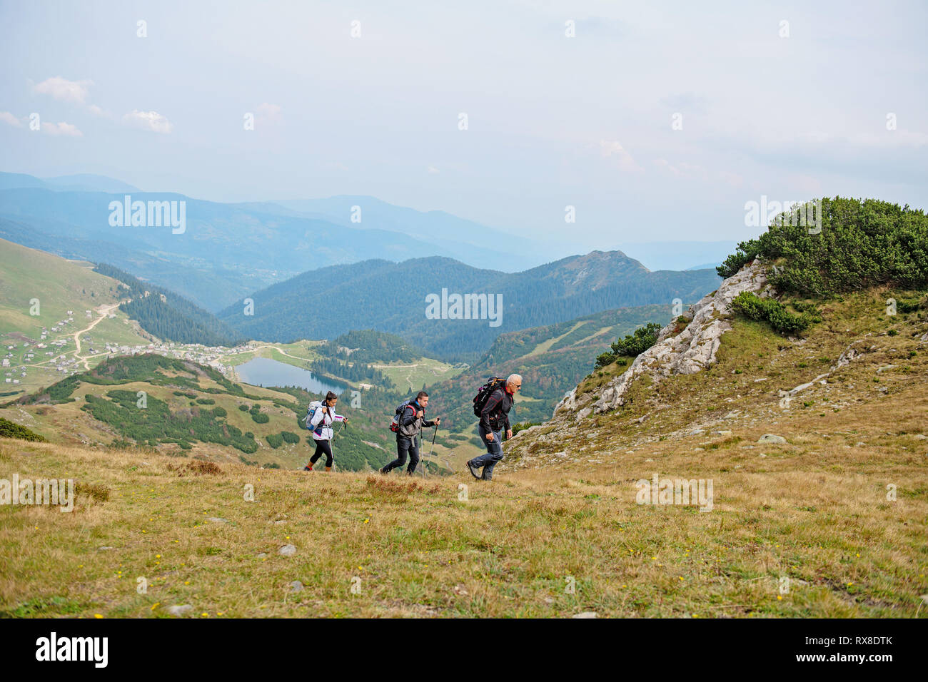 An elderly man giving a tour for a young group of people Stock Photo ...
