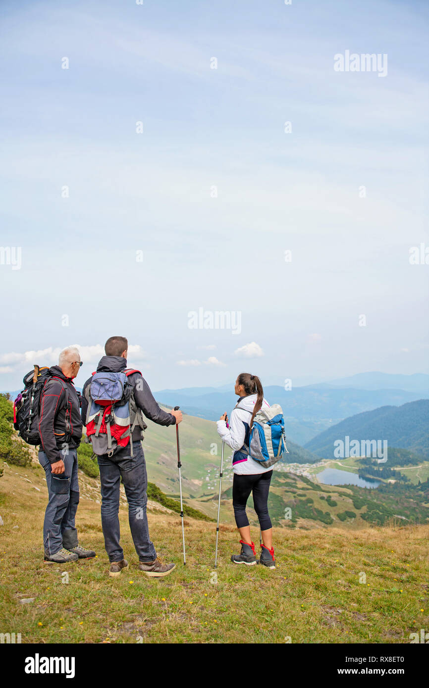 An elderly man giving a tour for a young group of people Stock Photo ...