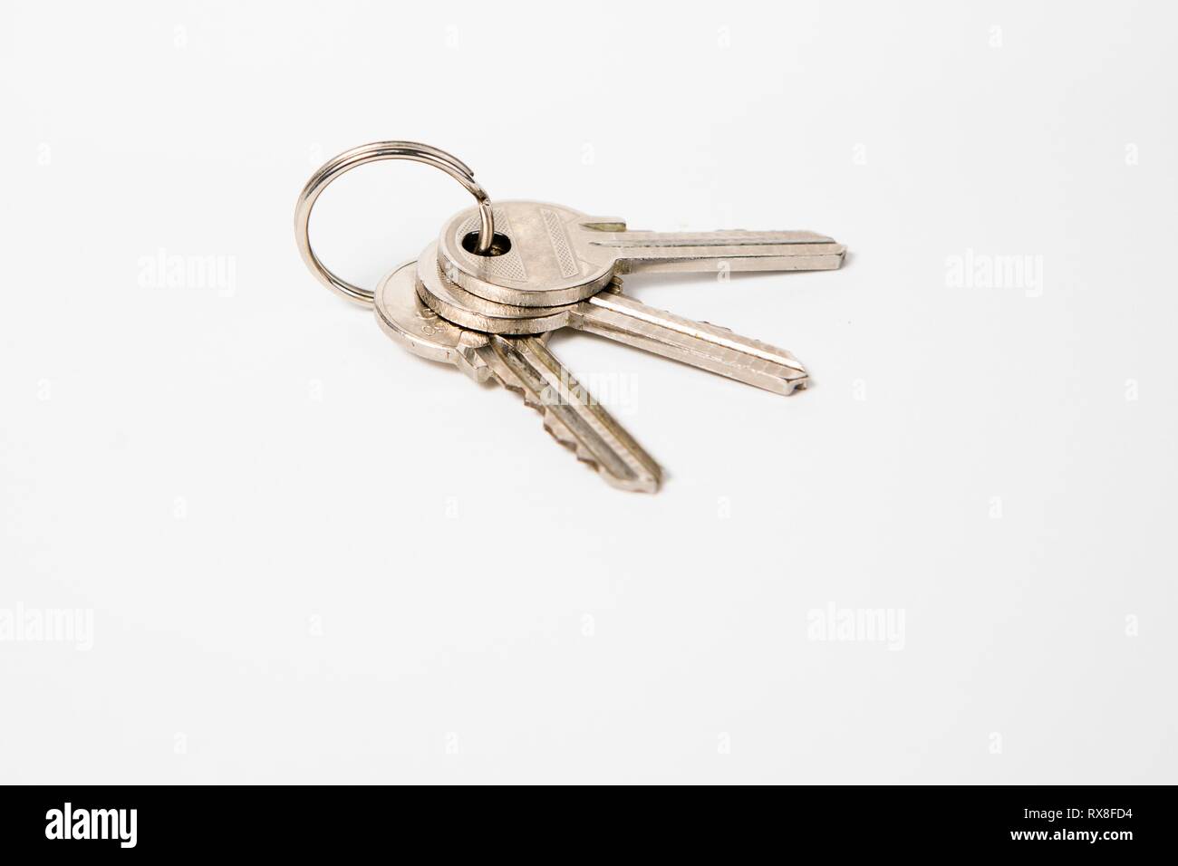 Three keys on white background - silver color - open you new apartment ...