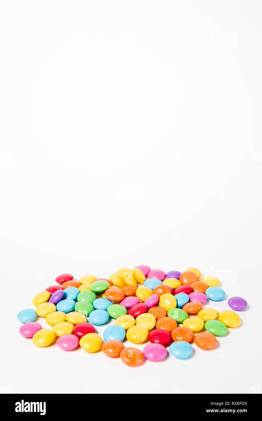 Pile of colorful sweets candies, side view - white background - concept ...