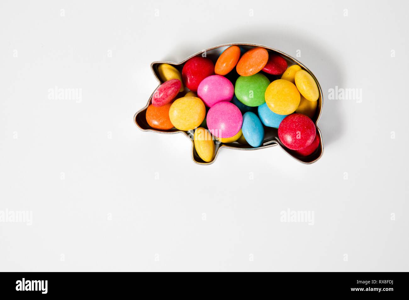 Pile of colorful sweets candies in shape of pig - hog, top view - white ...
