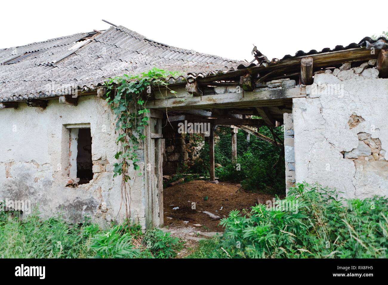 Old abandoned building with asbestos roof before collapse.Time is ...