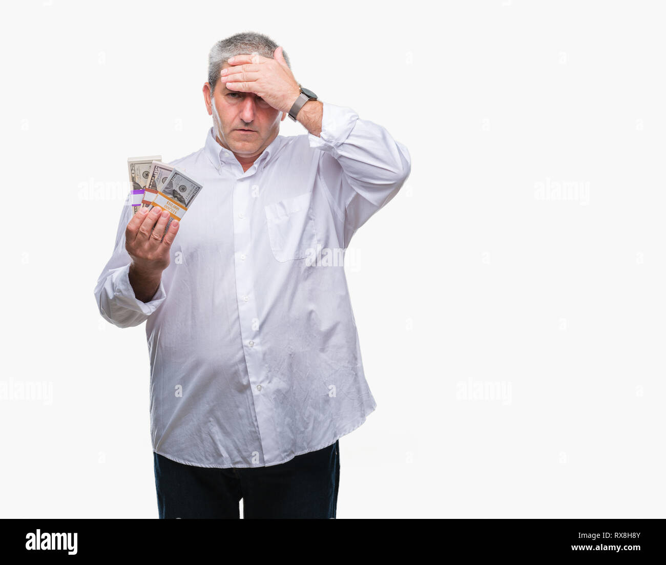 Handsome senior man holding bunch of money over isolated background ...