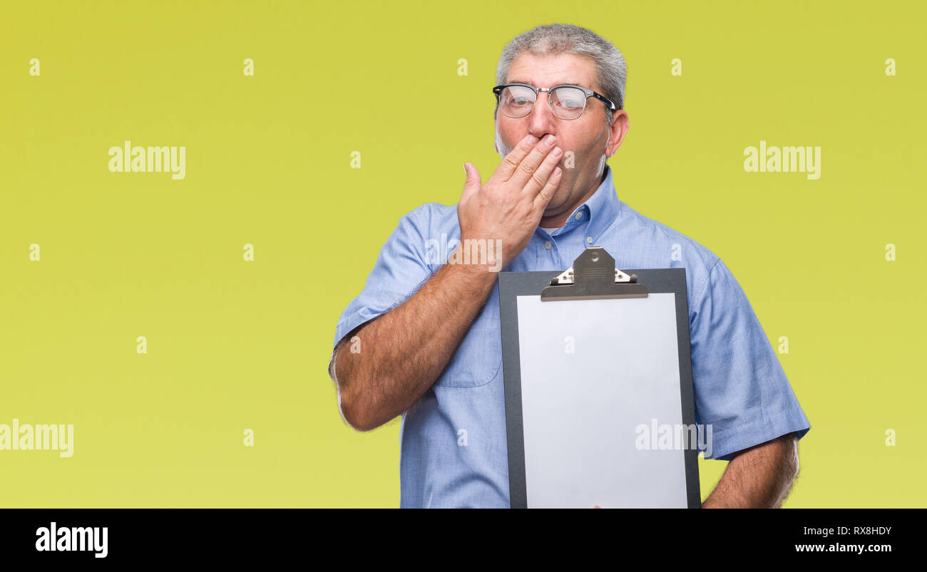 Handsome senior inspector man holding clipboard over isolated ...