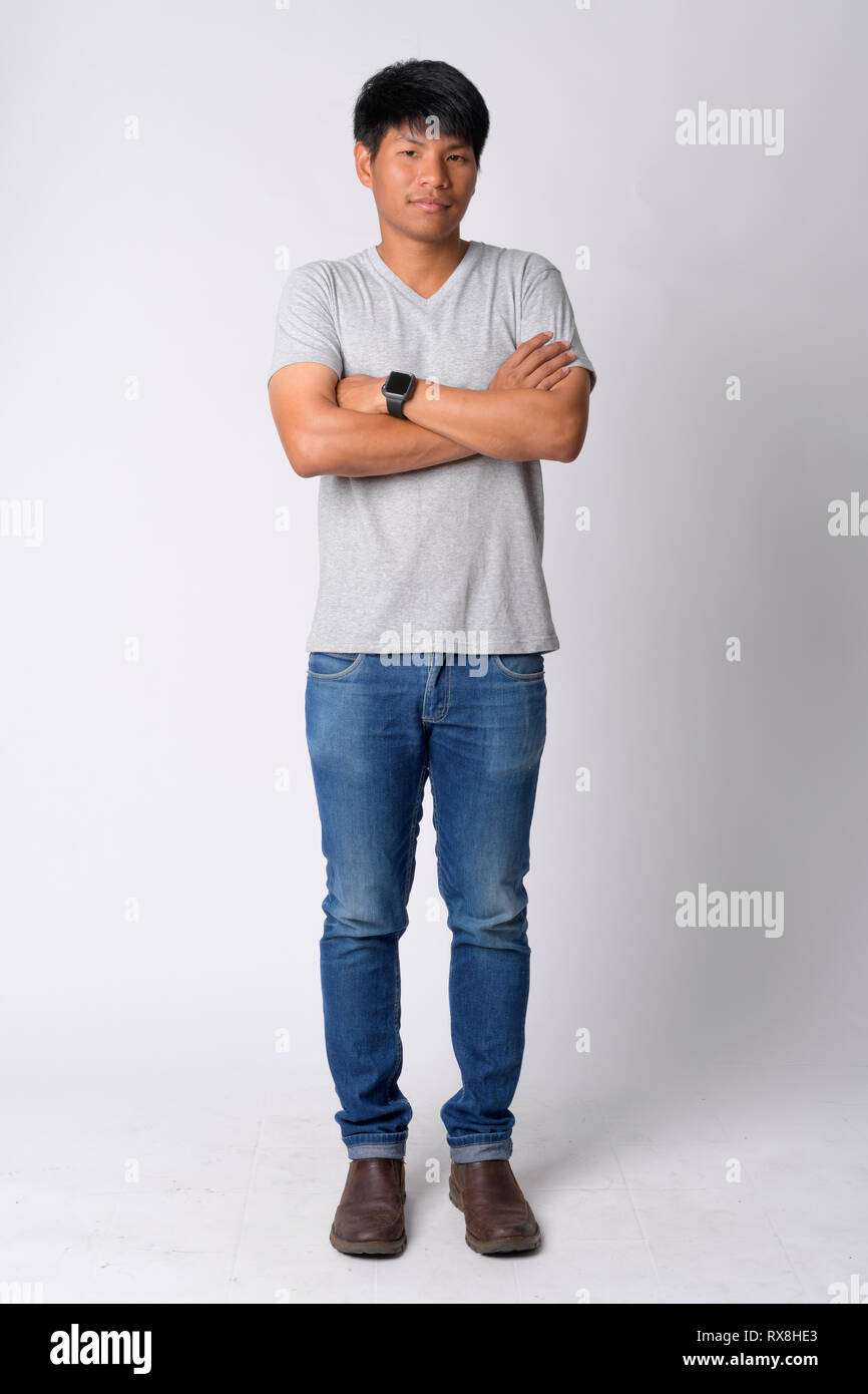 Full body shot of young Asian man with arms crossed Stock Photo - Alamy
