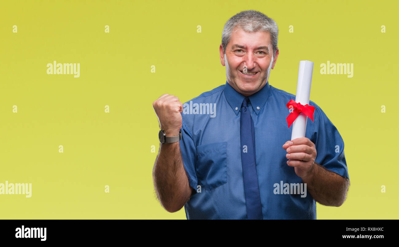 Handsome senior man holding degree over isolated background screaming ...