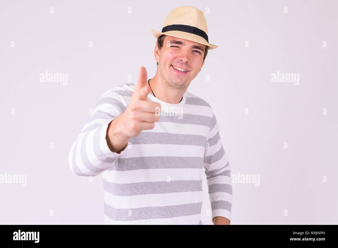 Portrait of happy tourist man winking and pointing at camera Stock ...