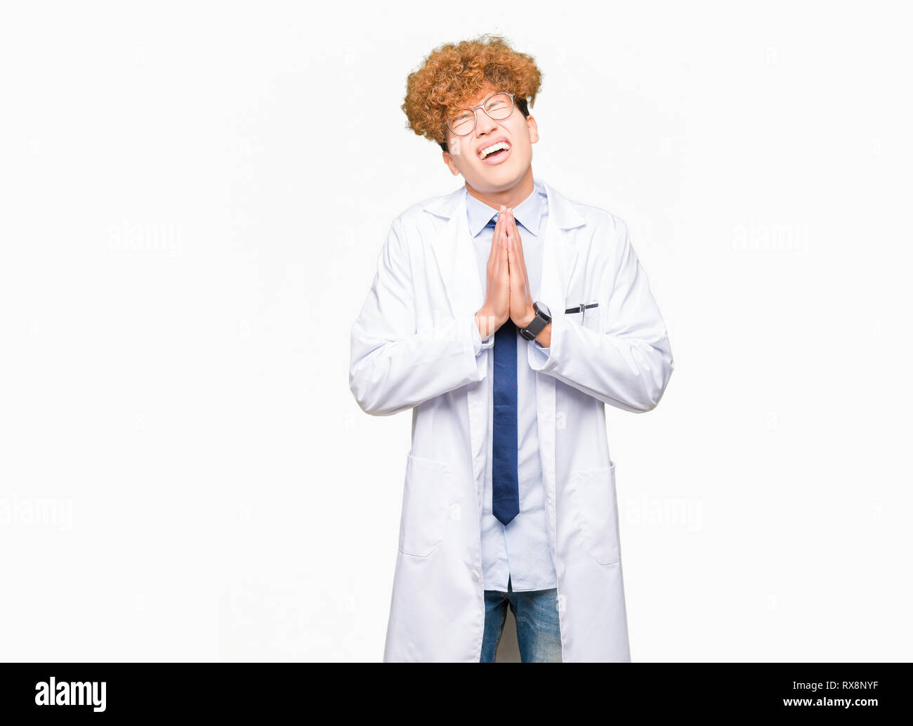 Young handsome scientist man wearing glasses begging and praying with ...