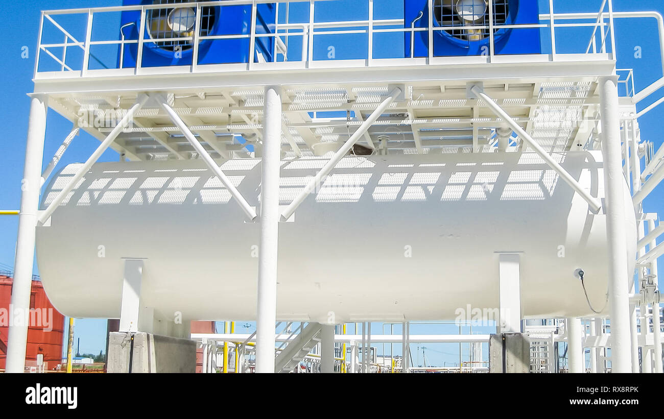 The tank with water and a ladder. Oil refinery. Equipment for primary ...