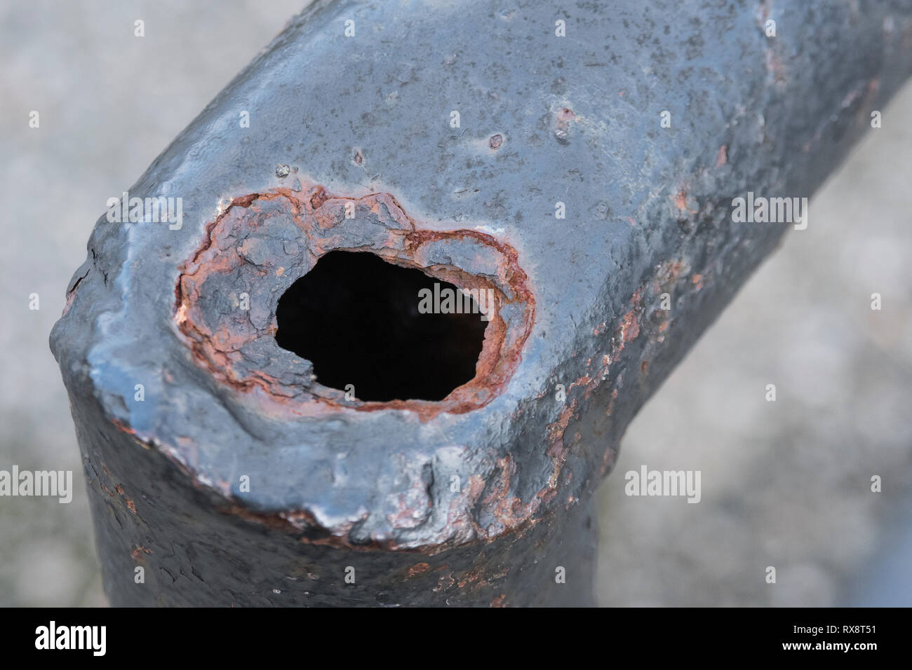 Close-up rusty iron pipe railings where the metal has corroded right ...