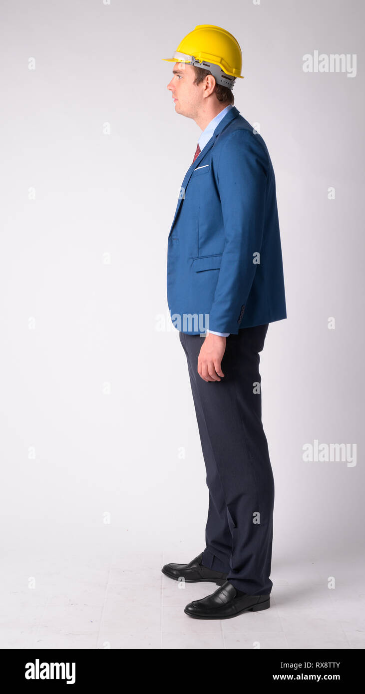 Full body shot profile view of businessman as engineer wearing hardhat ...