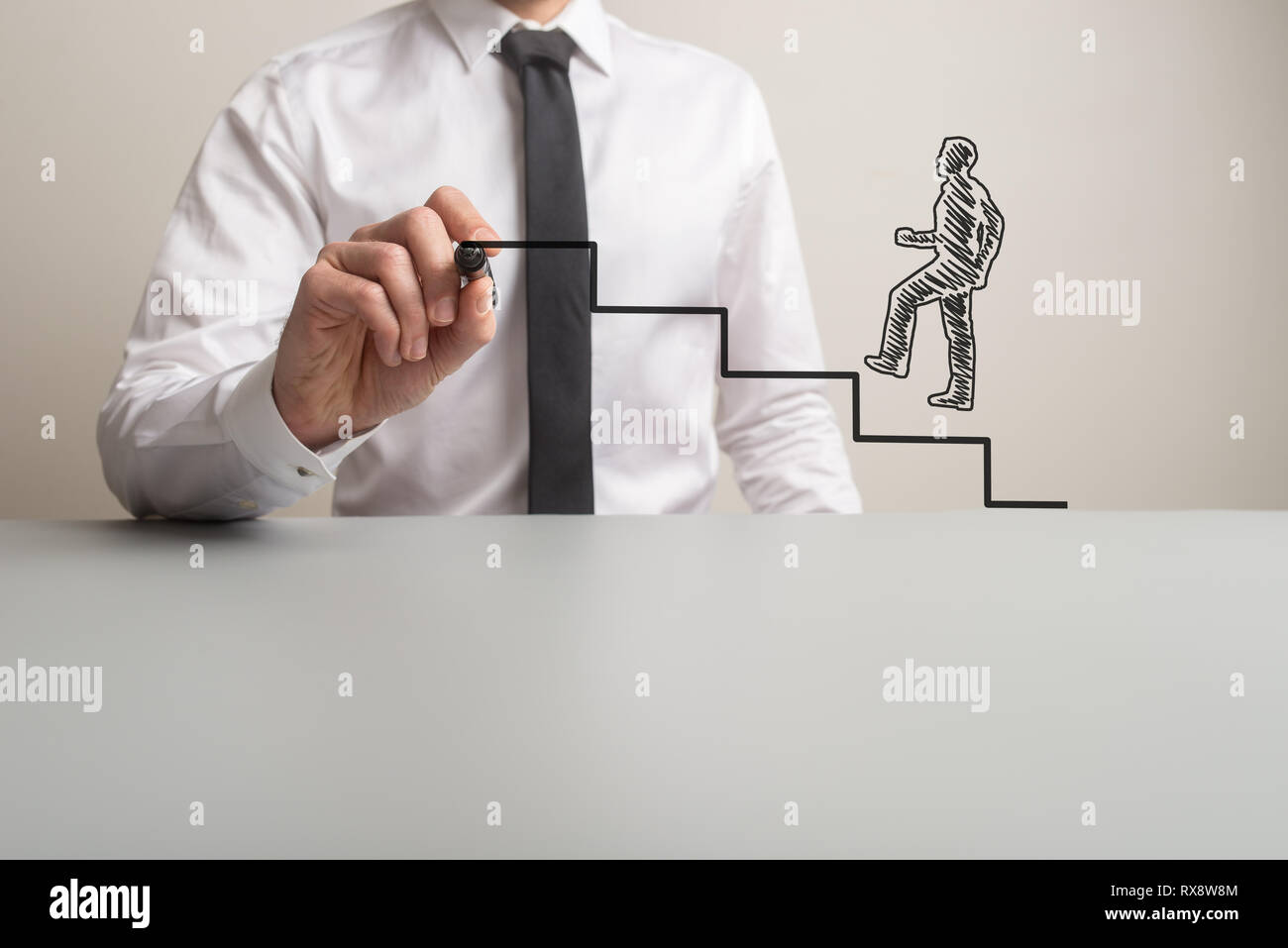 Business executive drawing steps for a handdrawn businessman to climb ...