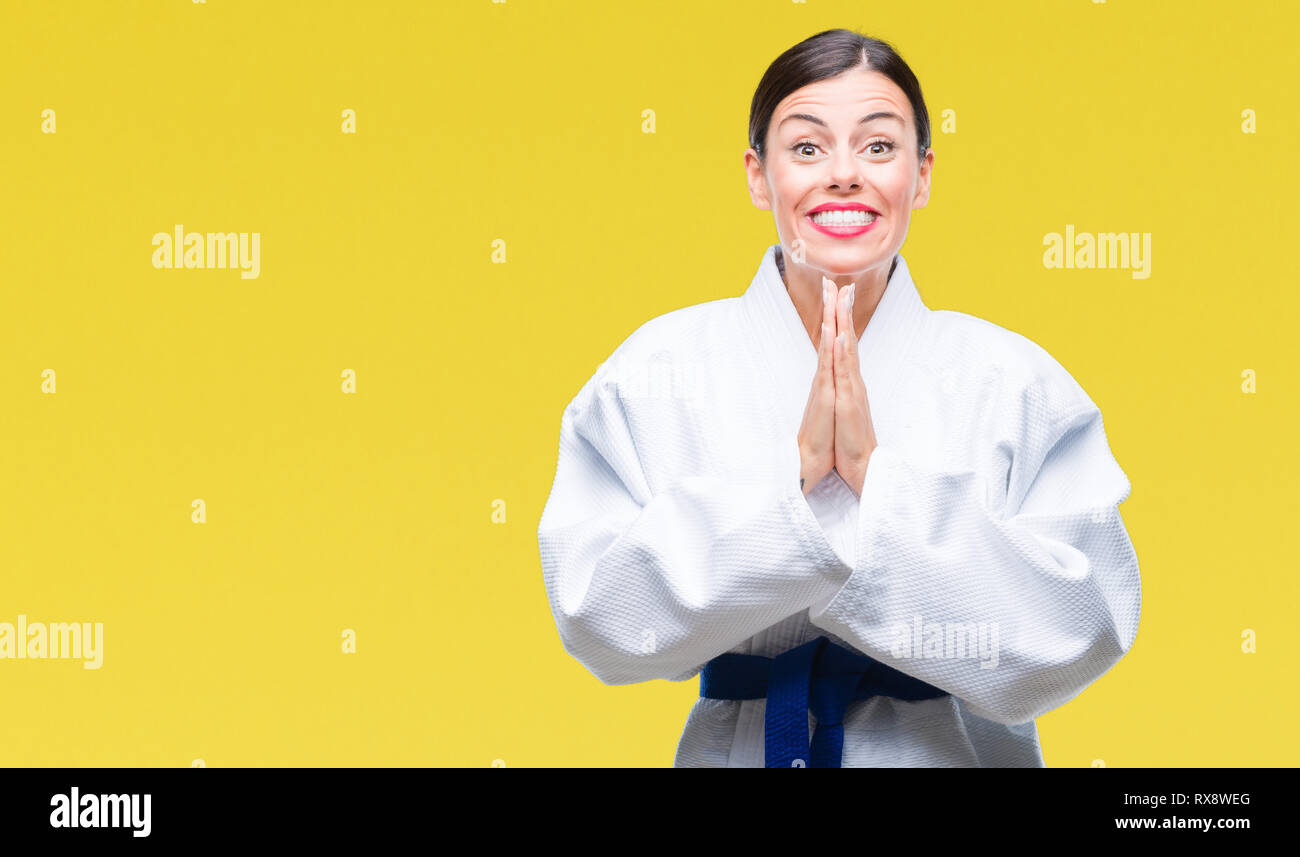 Young beautiful woman wearing karate kimono uniform over isolated ...