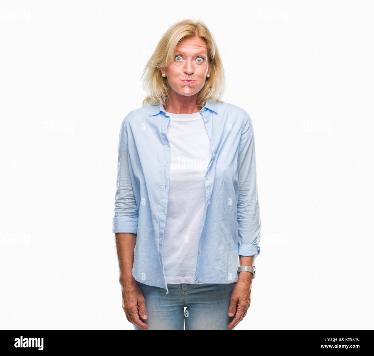 Middle age blonde woman over isolated background puffing cheeks with ...