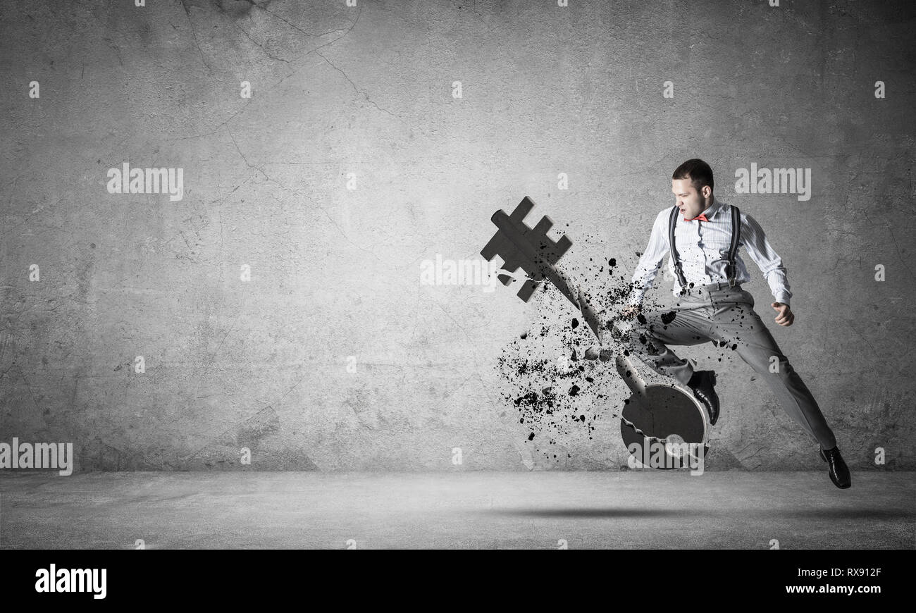 Breaking through access concept with furious man in room crashing ...