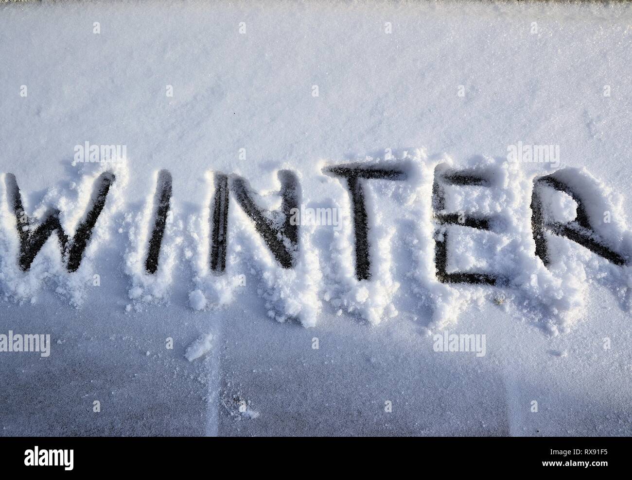 Lettering "Winter" in the snow Stock Photo - Alamy