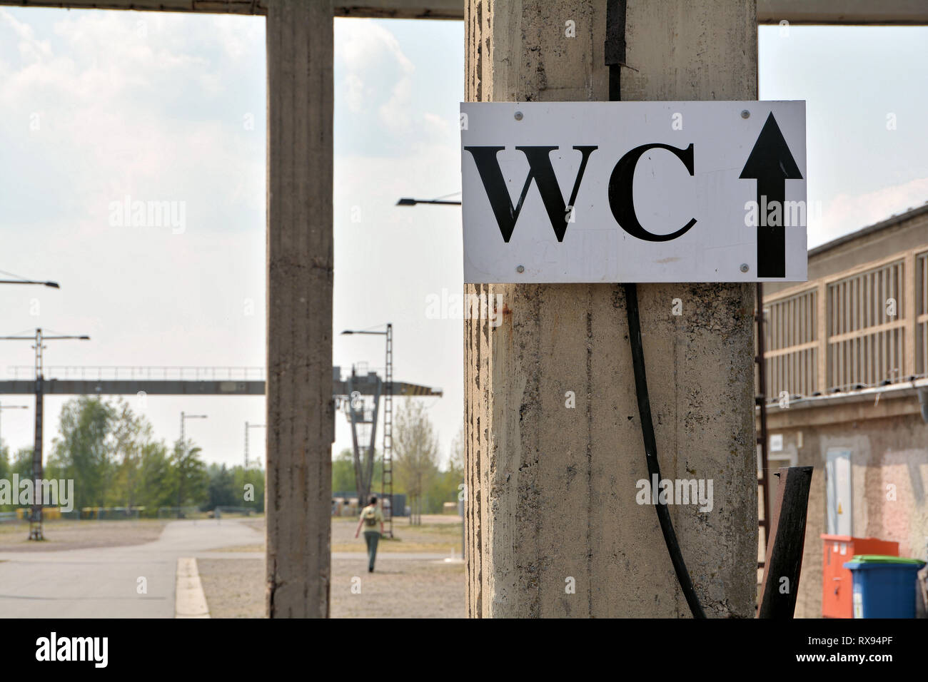 WC sign with directional arrow Stock Photo - Alamy