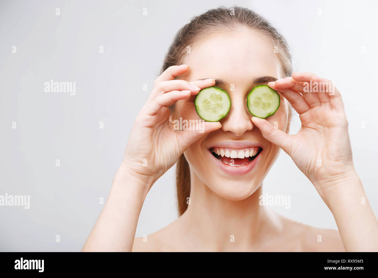 Photo of attractive young woman covering her eyes with cucumber Stock ...