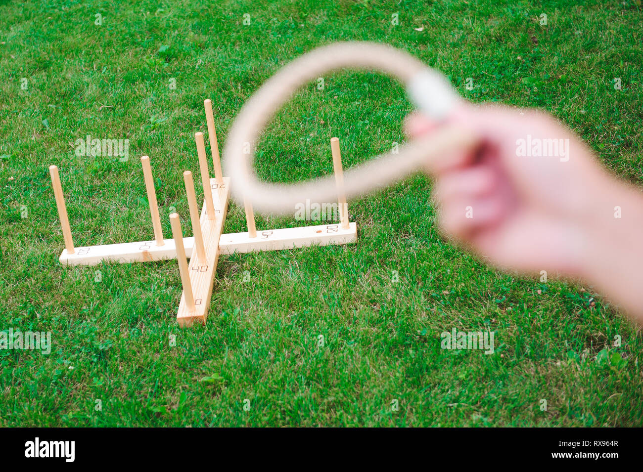 Outdoor games - guy playing ring toss in a park Stock Photo - Alamy