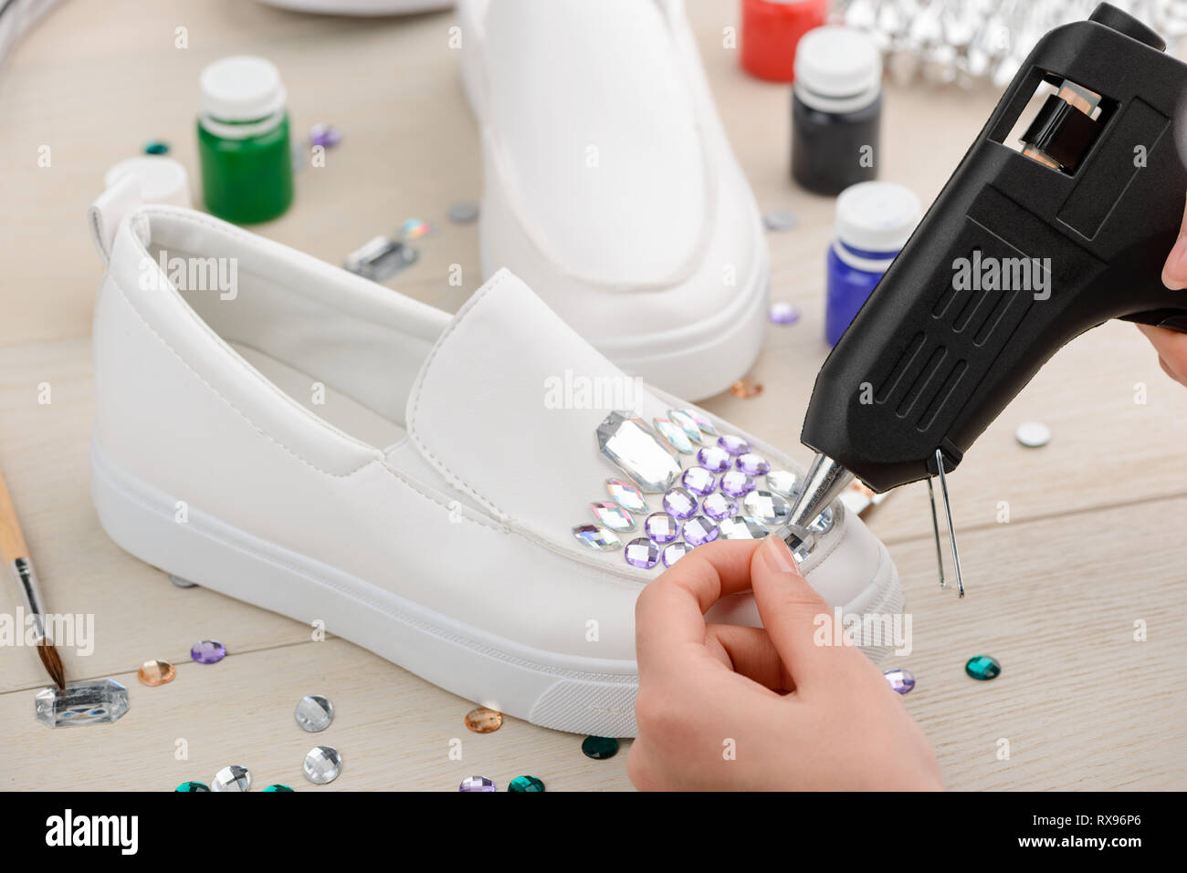Customization of shoes with rhinestones Stock Photo - Alamy