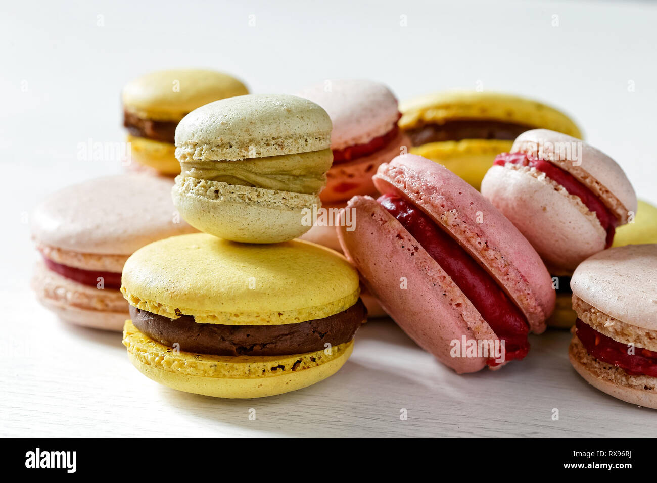 Macarons of various colors and sizes. White background Stock Photo - Alamy