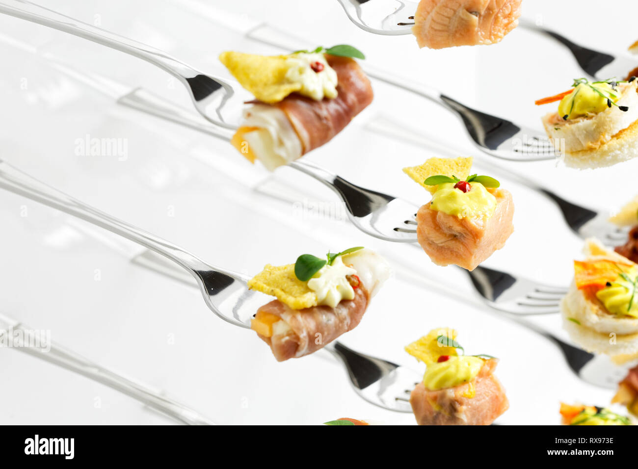 Mixed canapes on metal forks. White background Stock Photo - Alamy