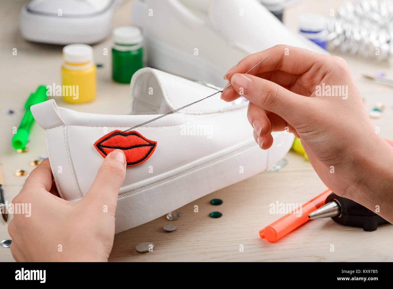 Girl sewing a lips patch Stock Photo - Alamy