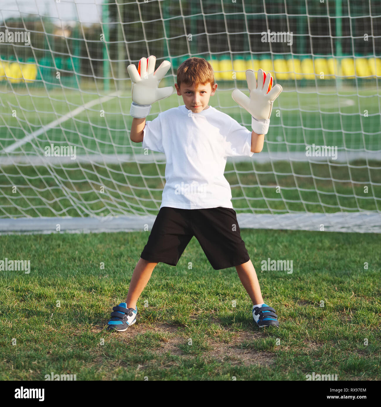 little happy boy on football field Stock Photo - Alamy