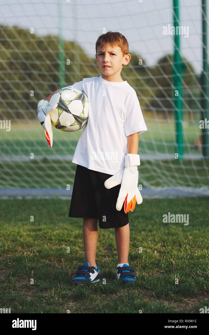 little happy boy on football field Stock Photo - Alamy