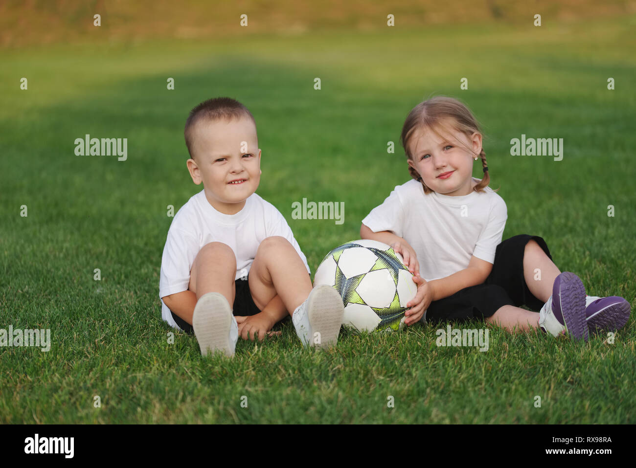 little happy boy on football field Stock Photo - Alamy