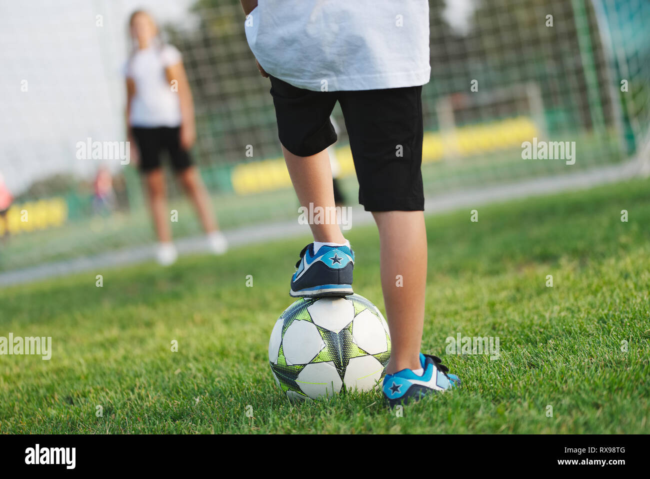 little happy boy on football field Stock Photo - Alamy