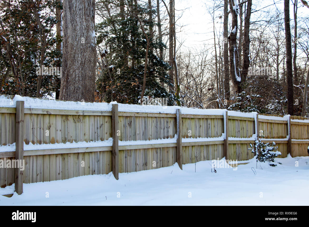 Snow on Wooden Fence Stock Photo - Alamy