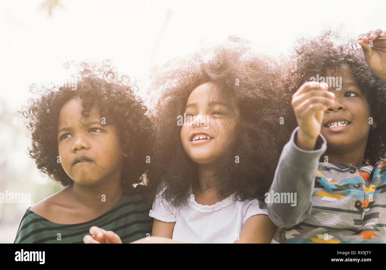 Portrait Happiness . Cute African american little boy and girl hug each ...