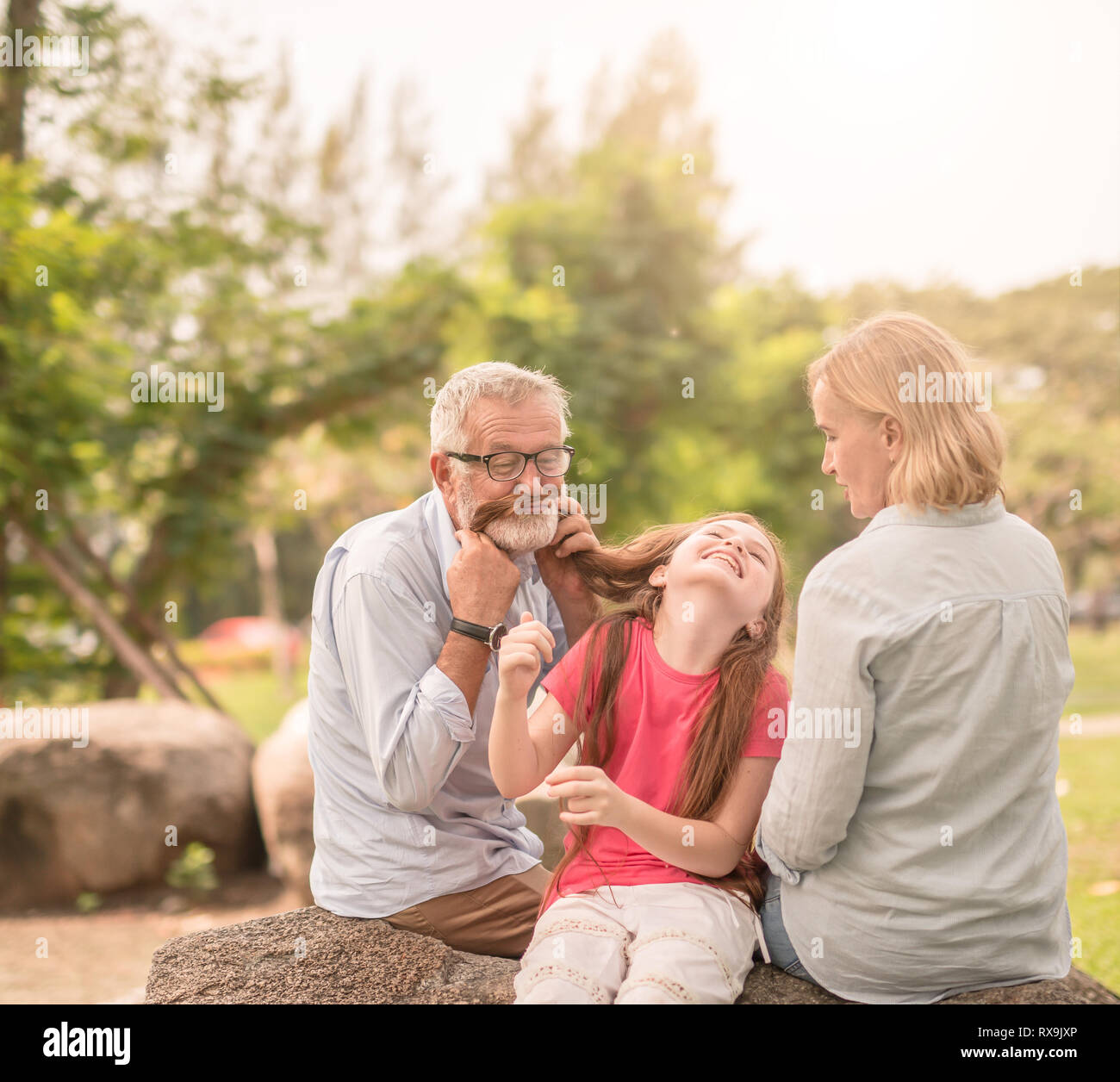 Happy family three playing garden hi-res stock photography and images ...