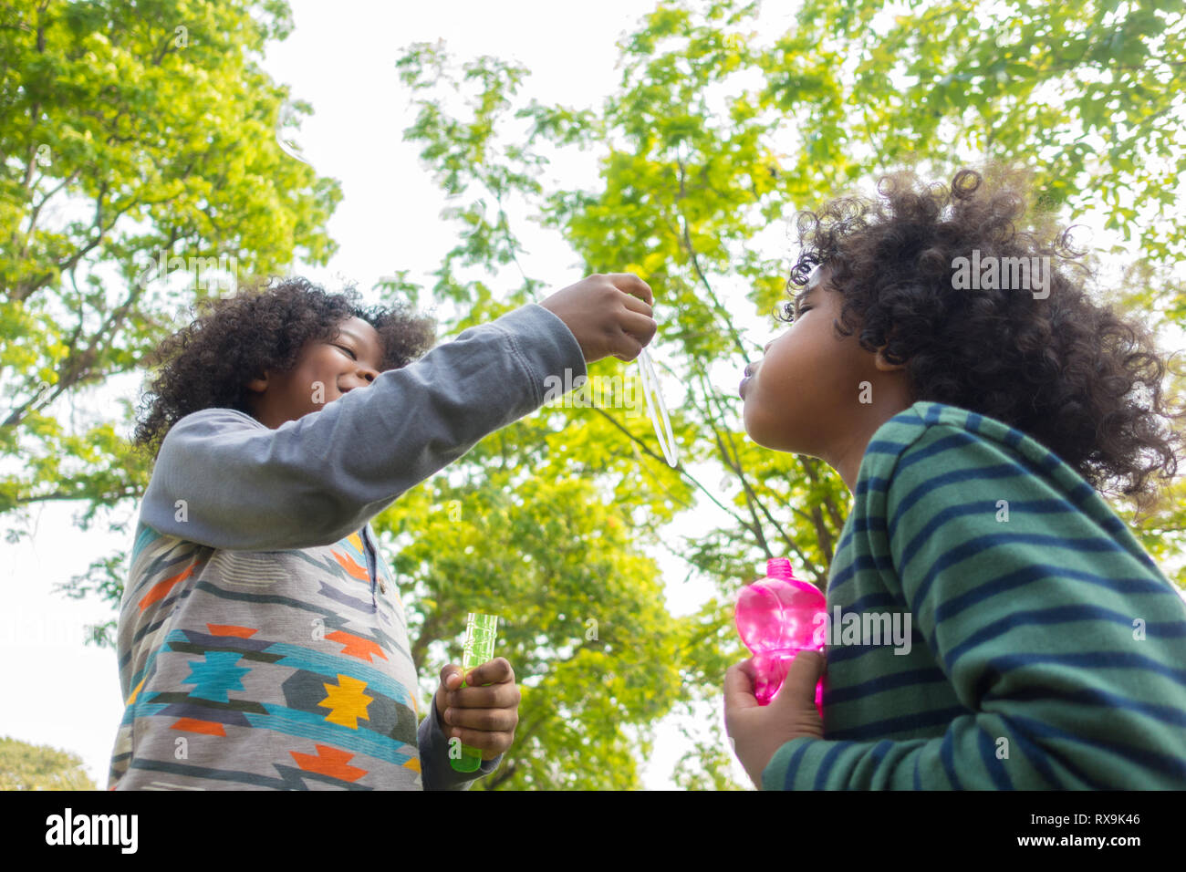 Kids Blowing Bubbles Together at the Field Stock Photo - Alamy