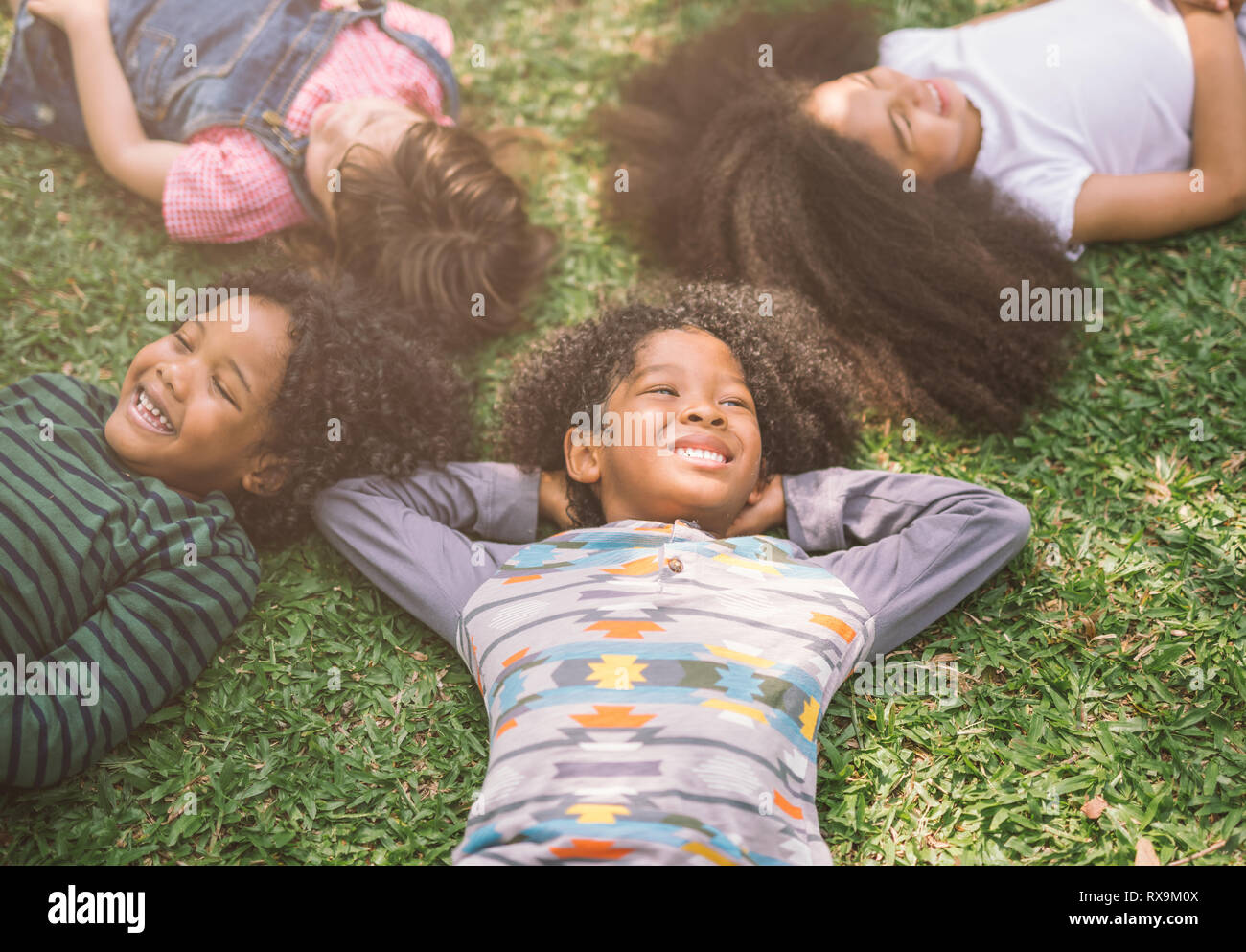 Boy laying down in grass hi-res stock photography and images - Alamy