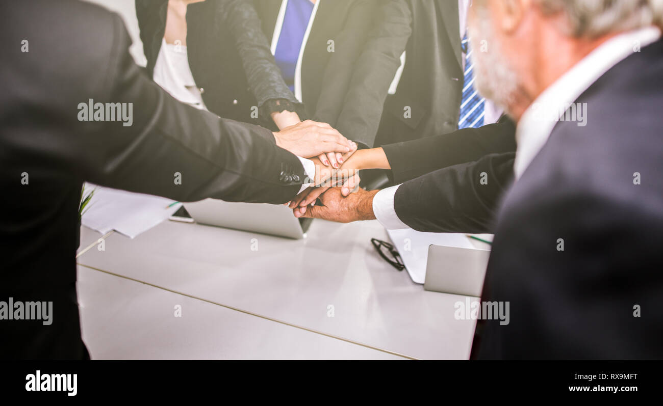 Business team stack hands support concept in office Stock Photo - Alamy
