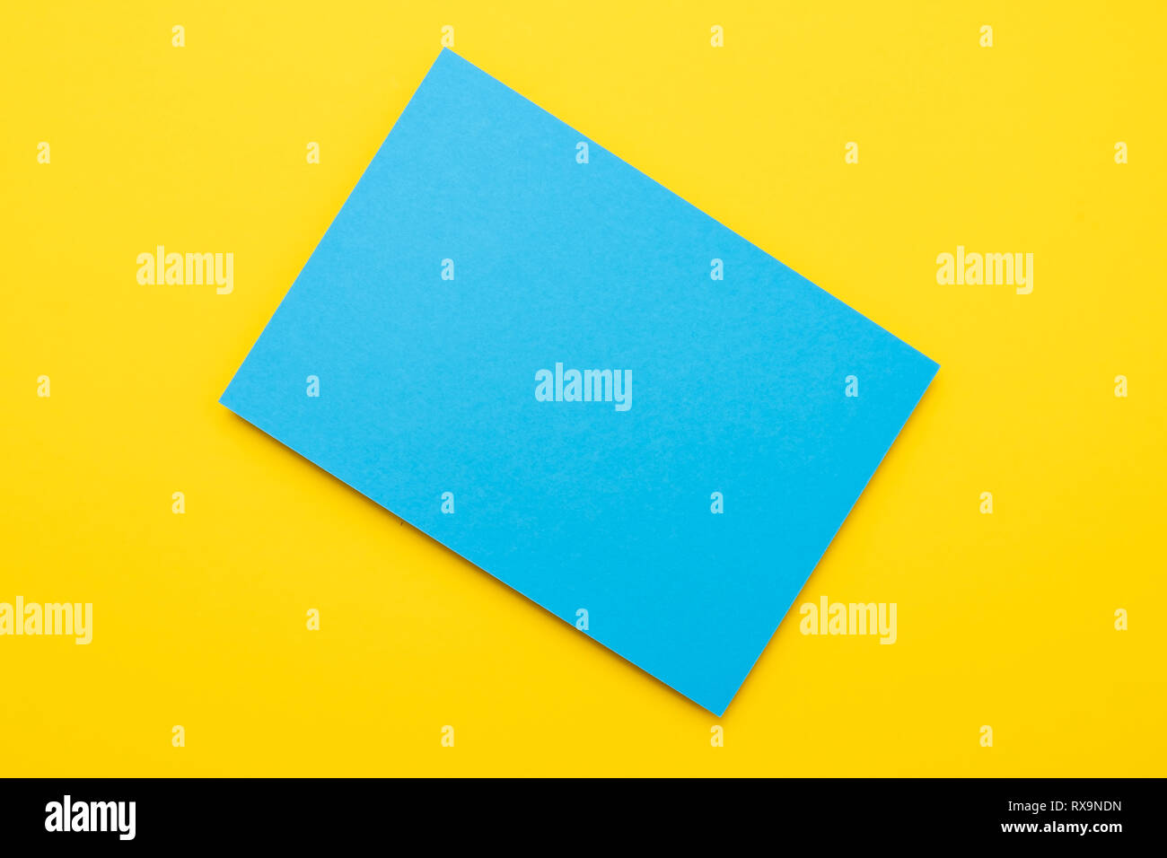 One blue paper on yellow background. Copyspace for your text Stock ...