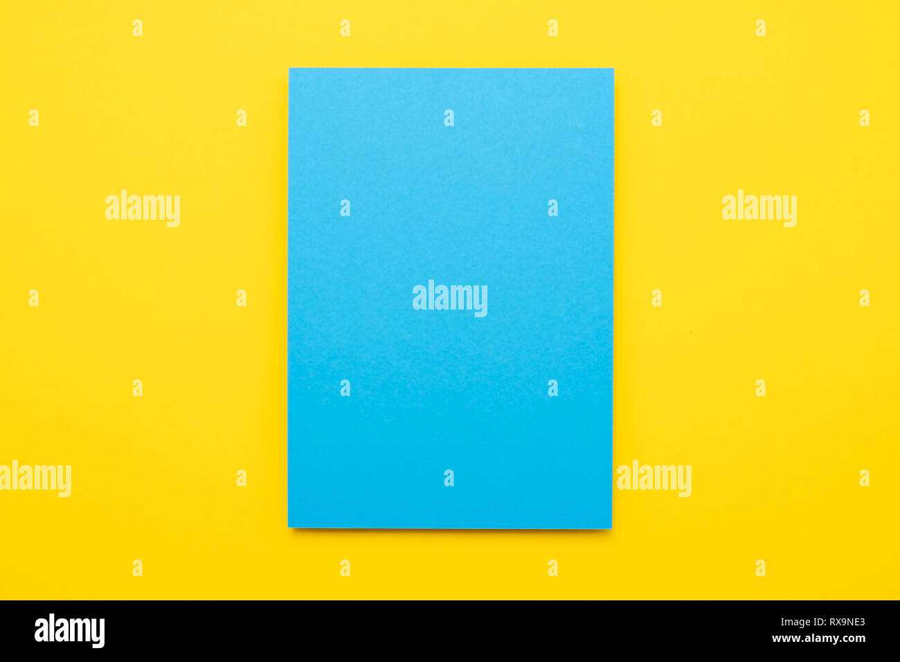 One blue paper on yellow background. Copyspace for your text Stock ...