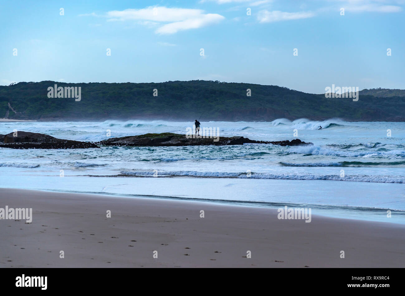 Surf fishing at One Mile Beach, Australia Stock Photo - Alamy