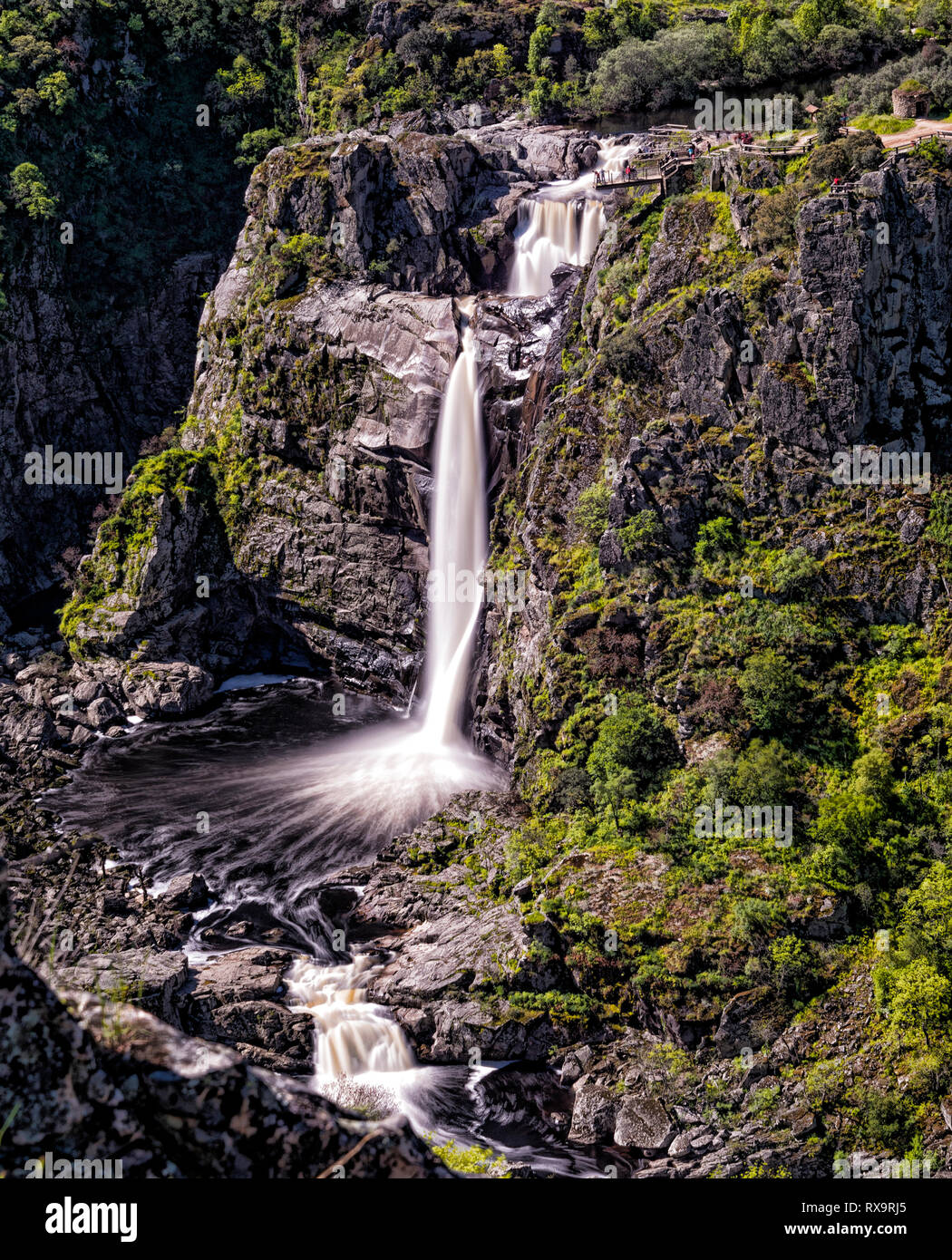 Scenic view of waterfall splashing on rock Stock Photo - Alamy