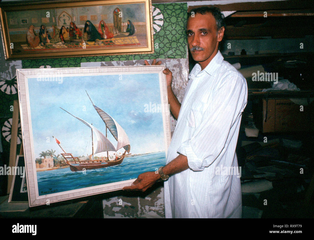 Bahraini artist Abdul Karim Al-Orrayed b.1934 with a painting, 1969 ...