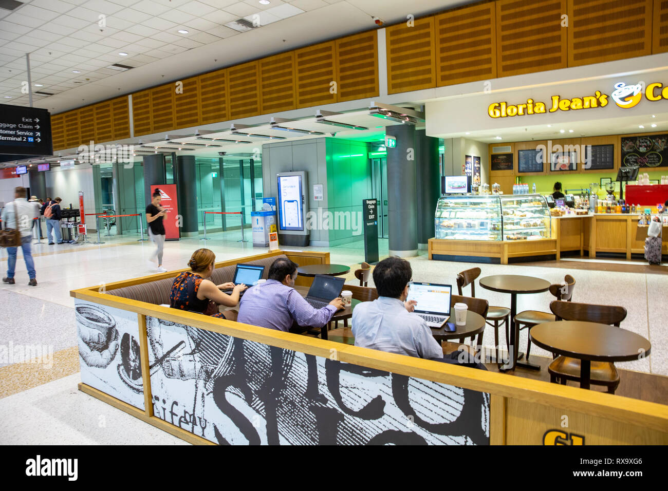 Two men and a woman working on their laptop computers inside Sydney ...