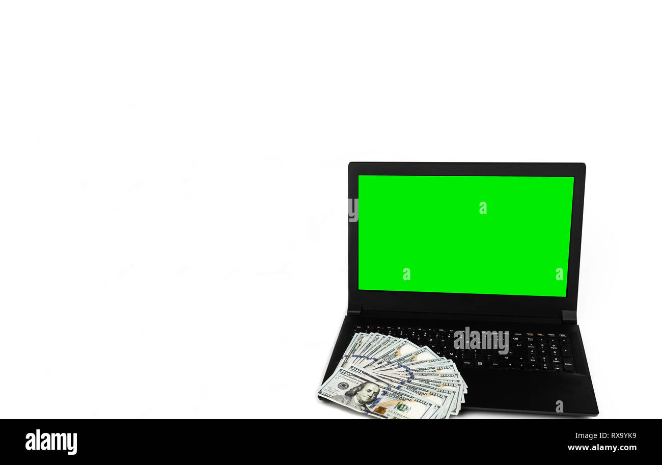 Horizontal shot of laptop or notebook with widespread of dollar cash ...