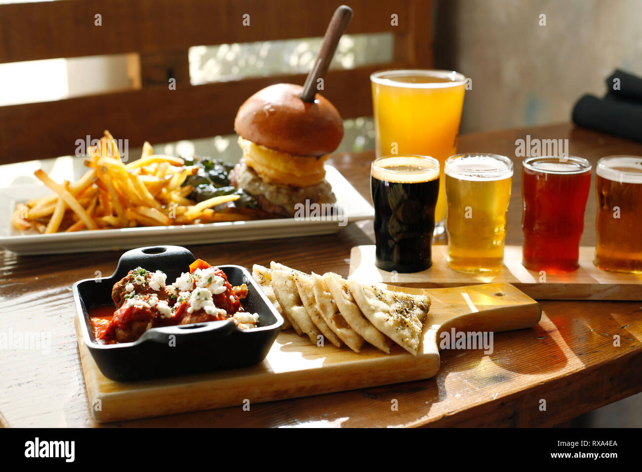 High angle view of fast food with beer served on wooden table in ...