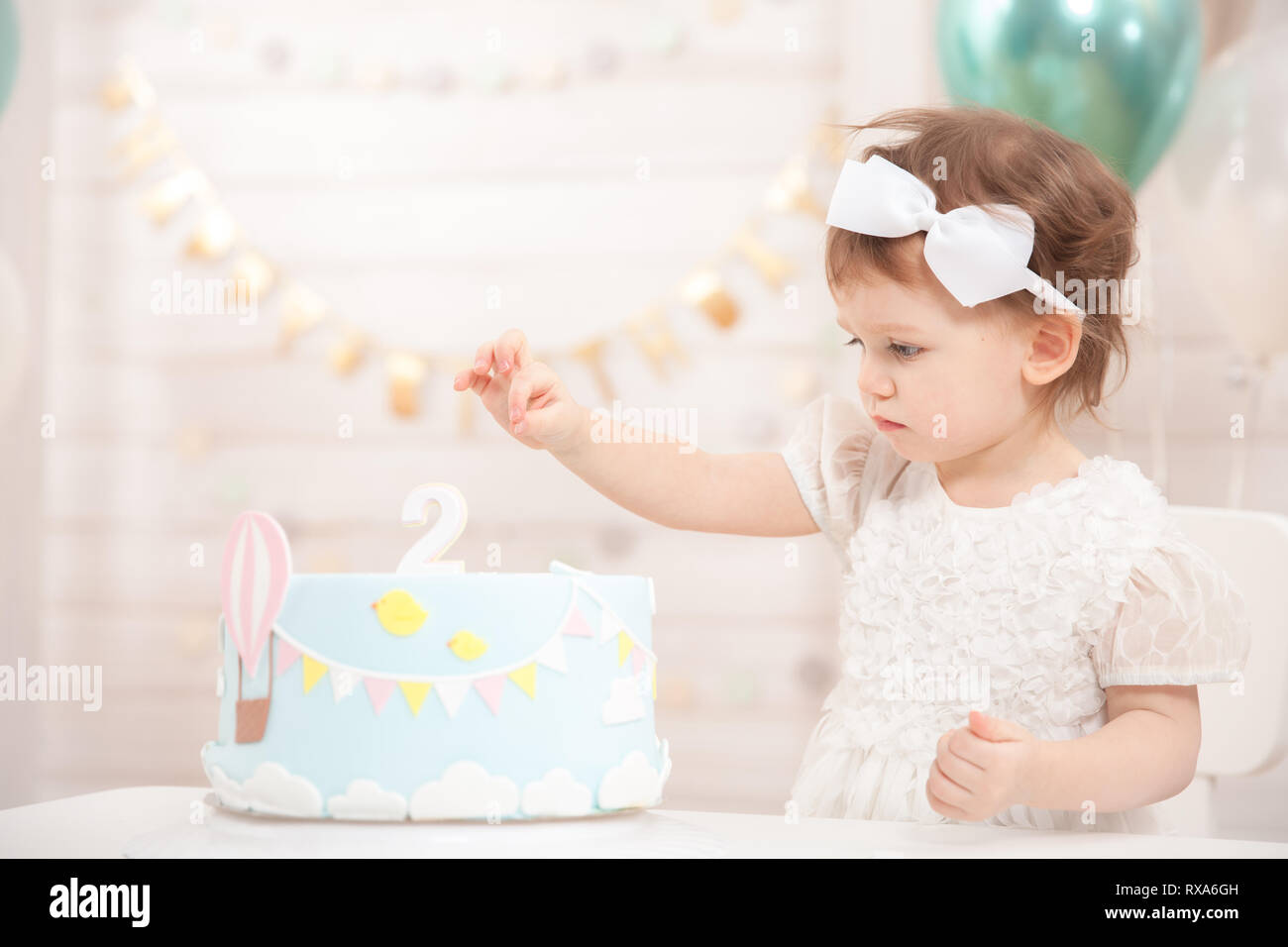 Little girl birthday party. Cute princess eat cake Stock Photo - Alamy