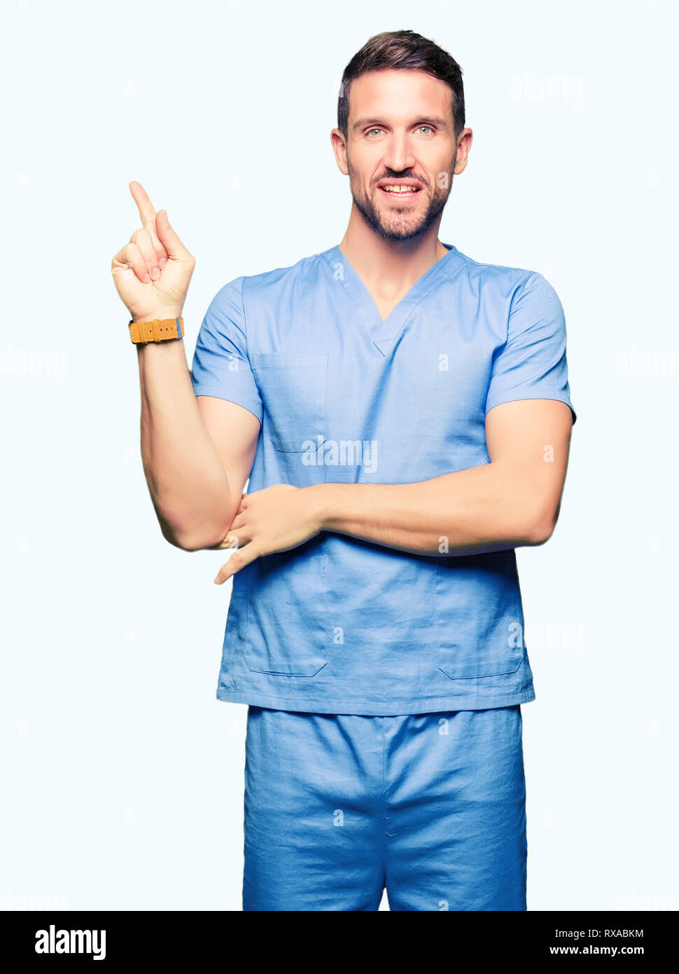 Handsome doctor man wearing medical uniform over isolated background ...