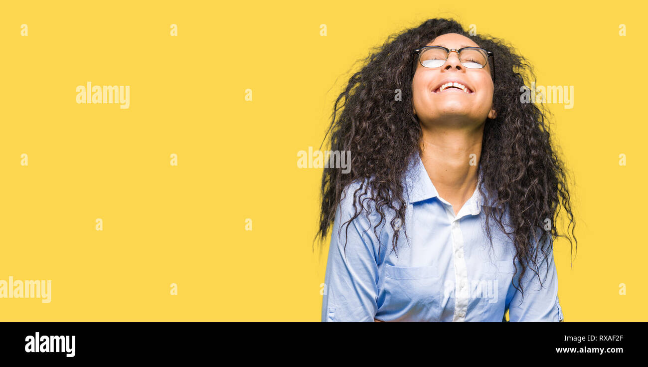 Young beautiful business girl with curly hair wearing glasses Smiling ...